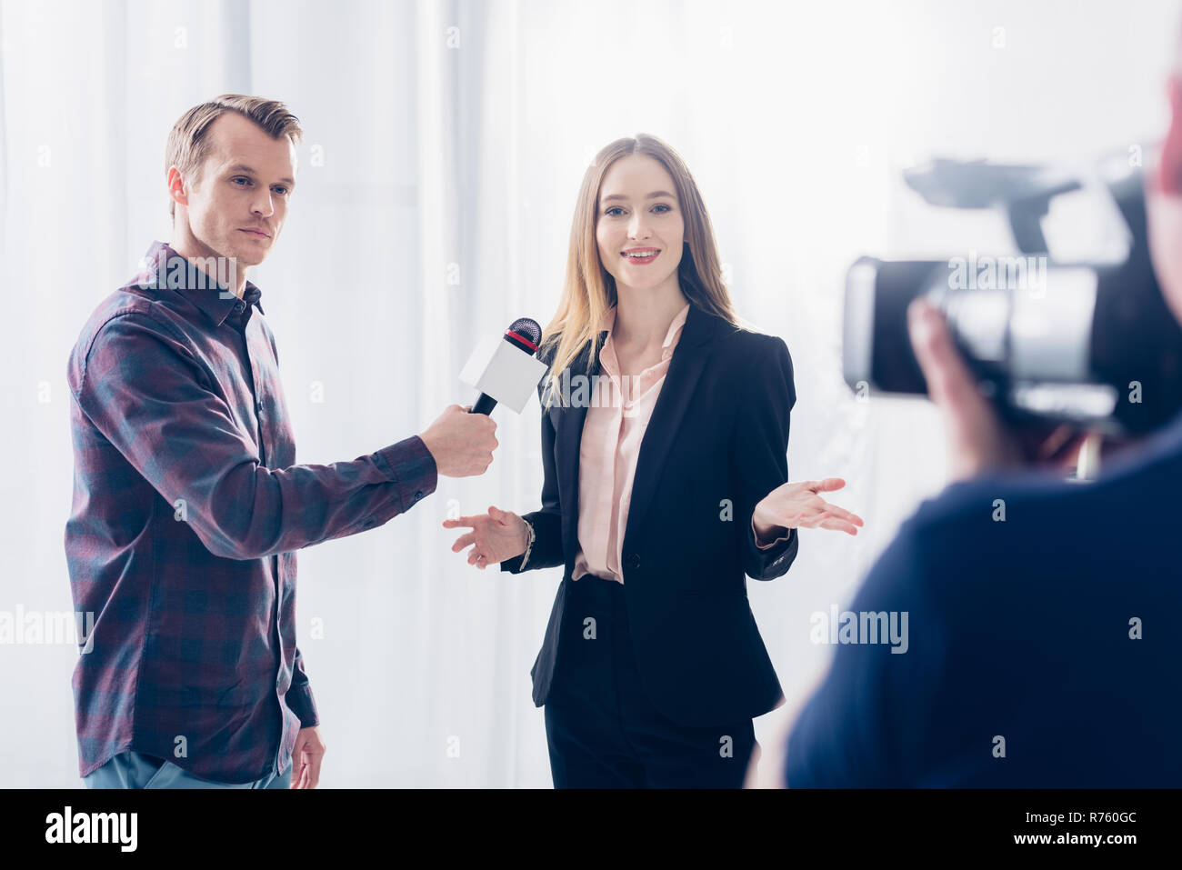 beautiful businesswoman in suit giving interview to journalist and ...