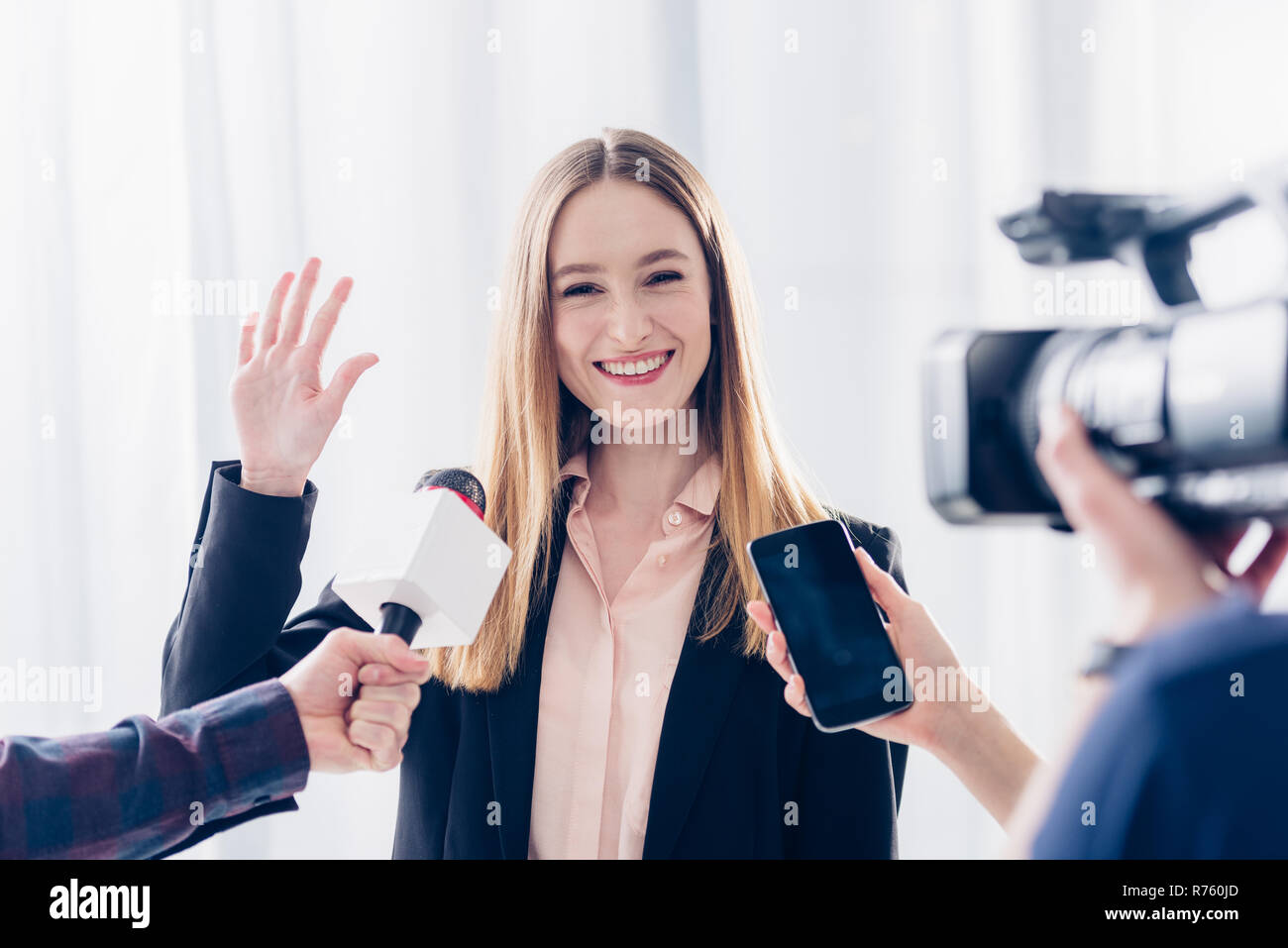 happy attractive businesswoman giving interview to journalists and ...