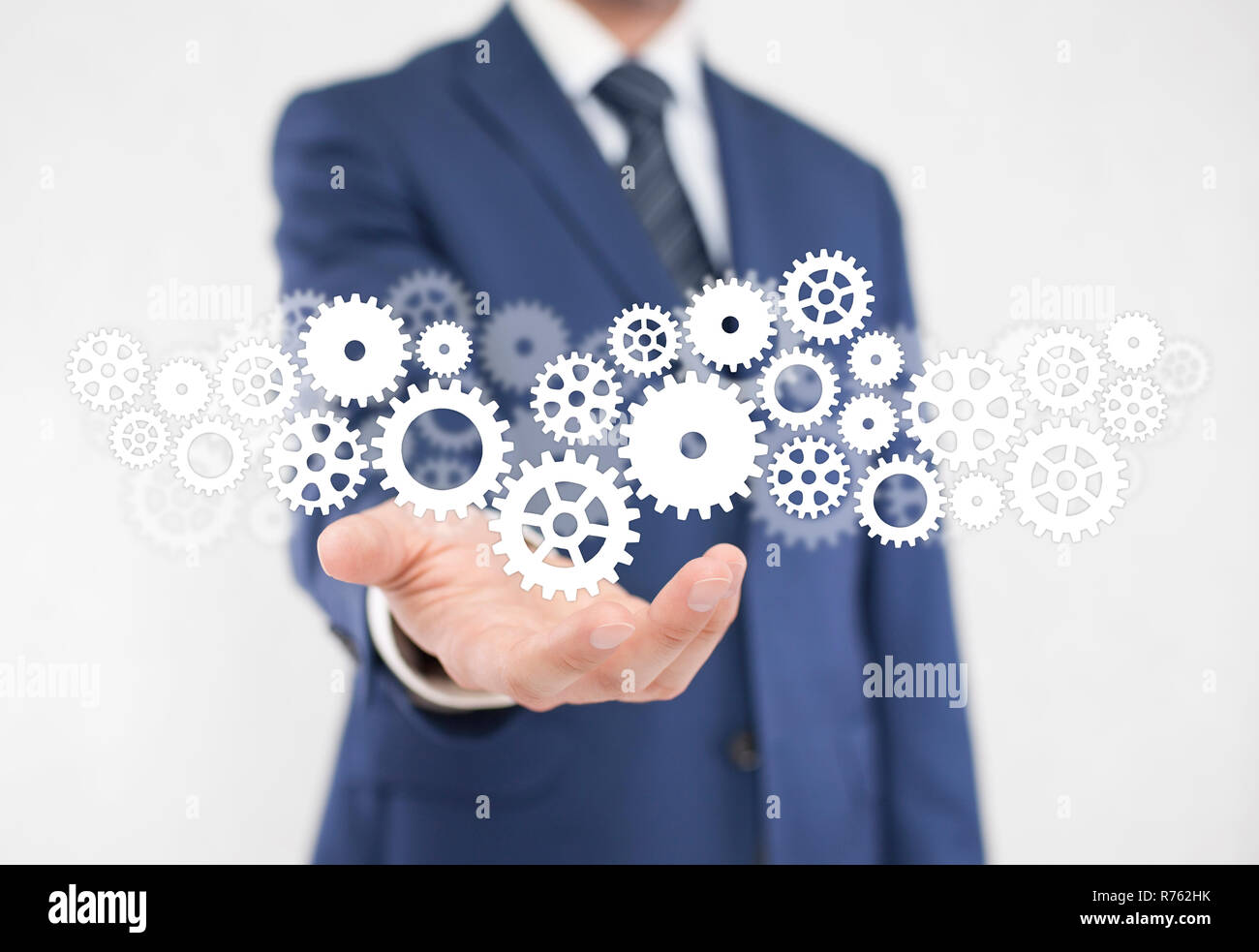 Businessman with gears, concept of well organized work process Stock ...