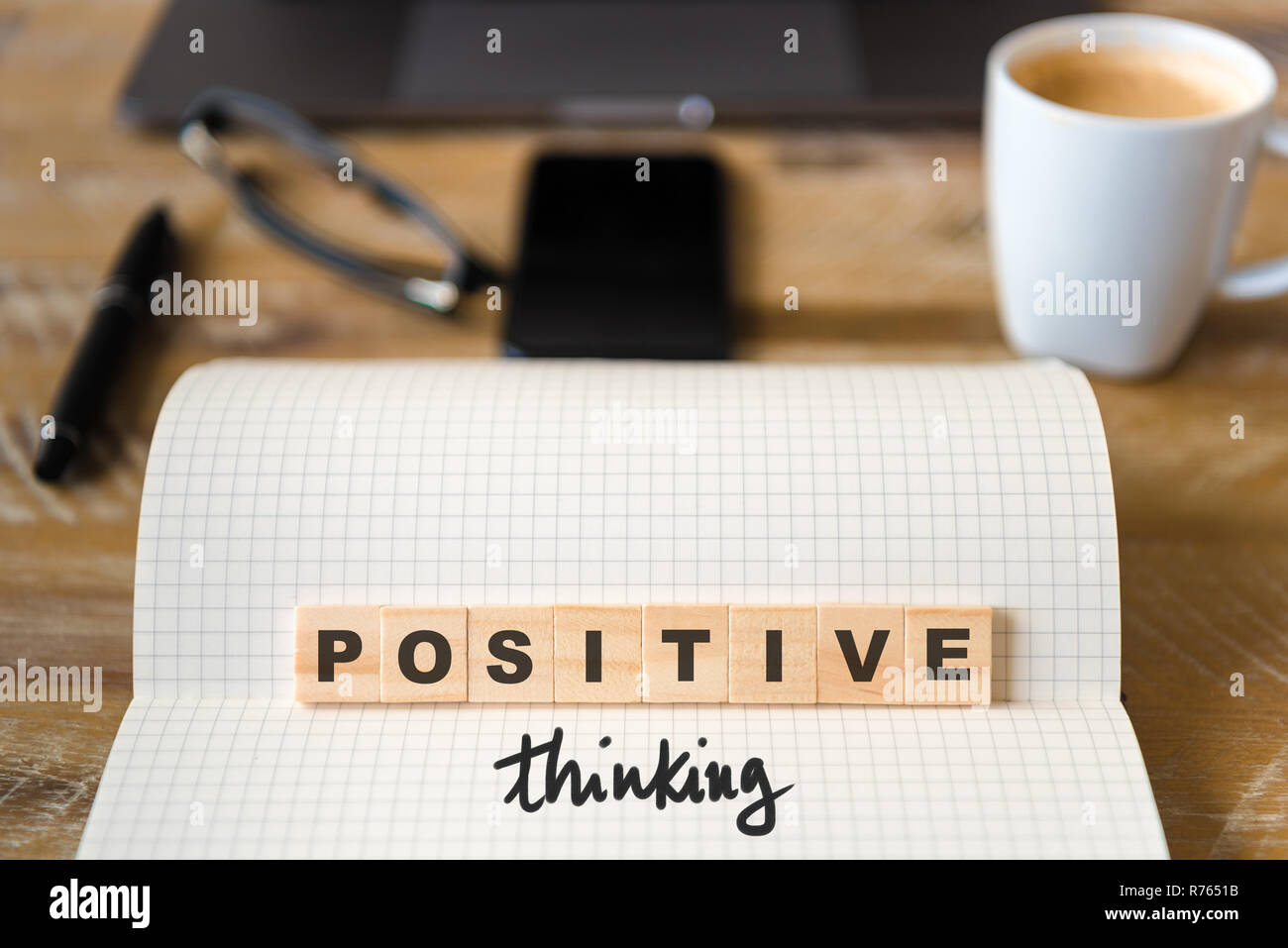 Closeup on notebook over wood table background, focus on wooden blocks ...
