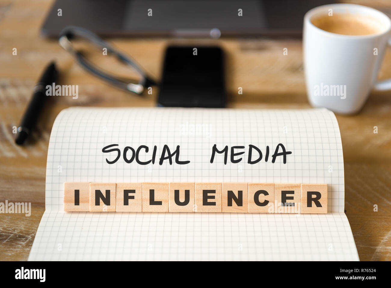 Closeup on notebook over wood table background, focus on wooden blocks ...