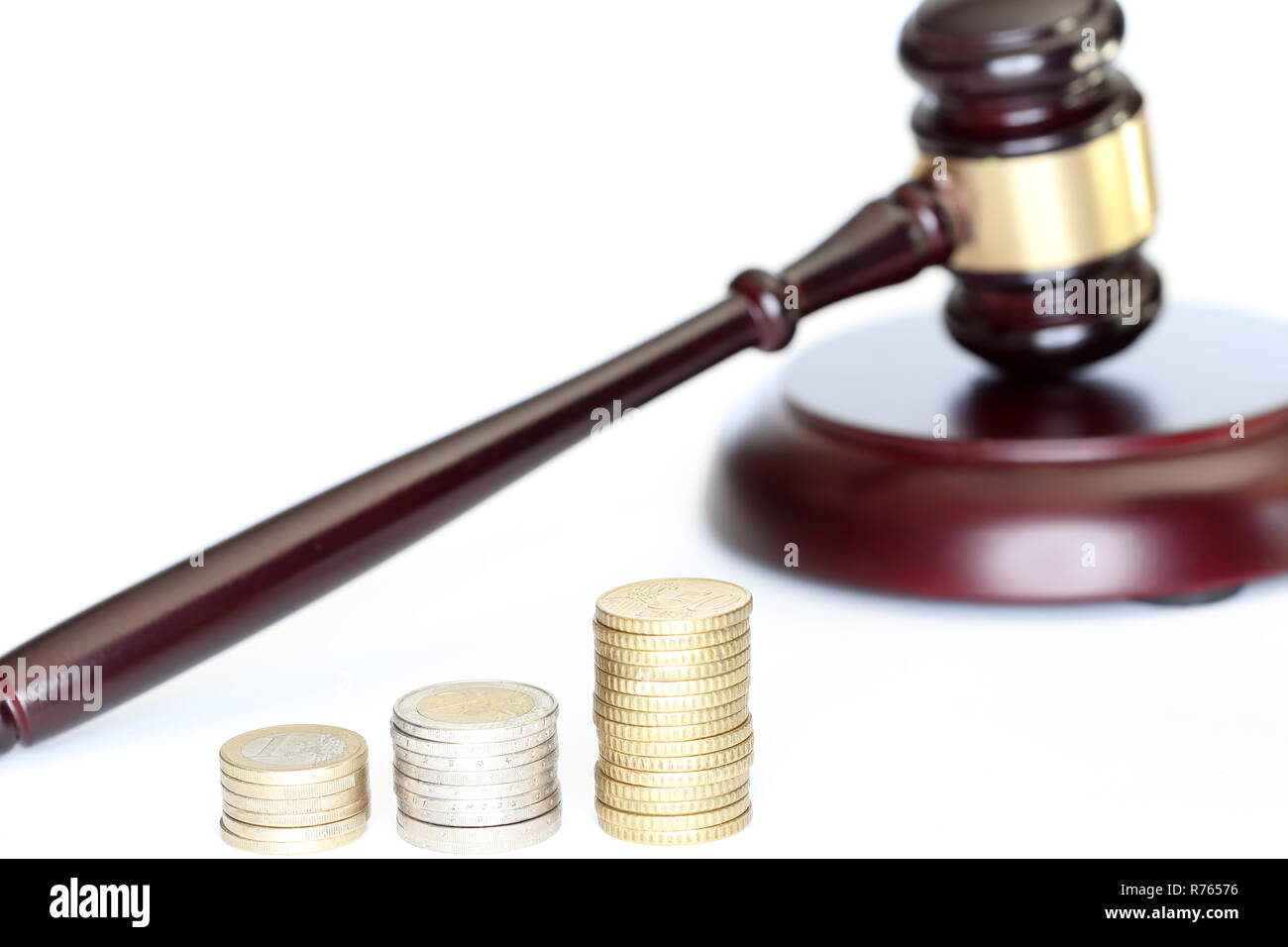 coins with hammer in the background Stock Photo - Alamy