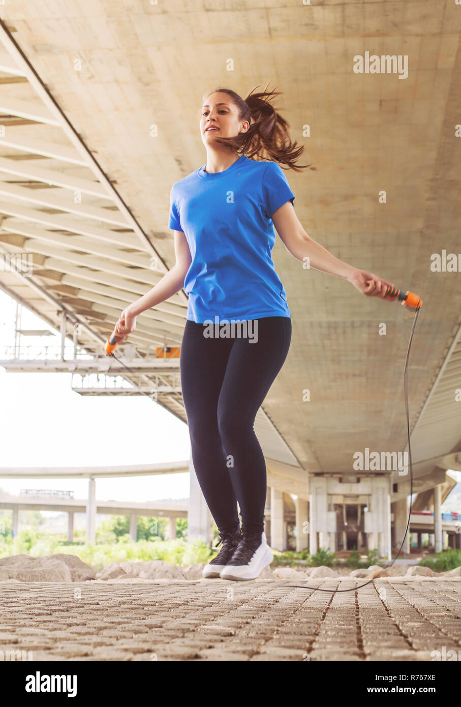 Fitness woman jumping rope outdoor Stock Photo - Alamy