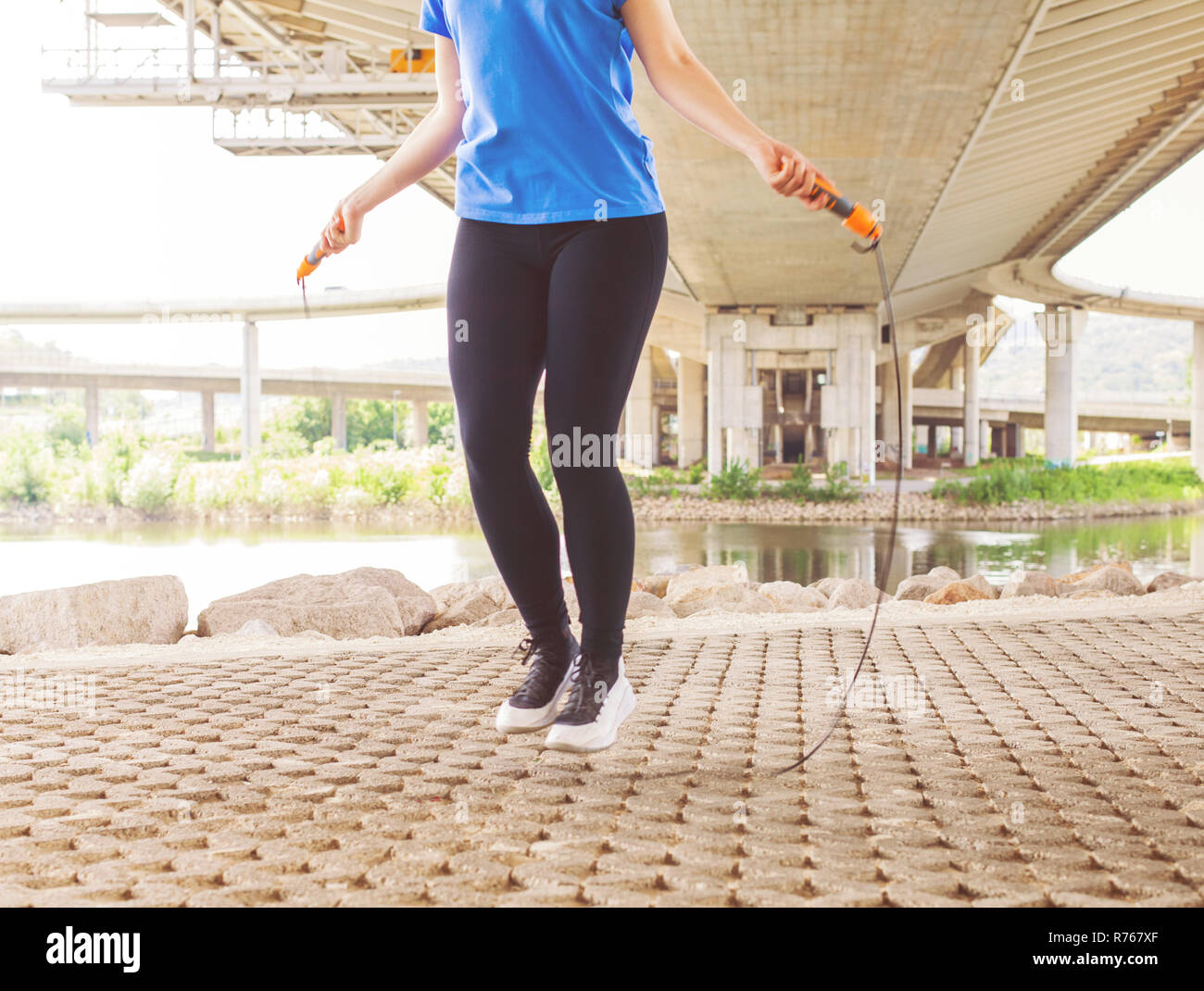 Fitness woman jumping rope outdoor Stock Photo - Alamy