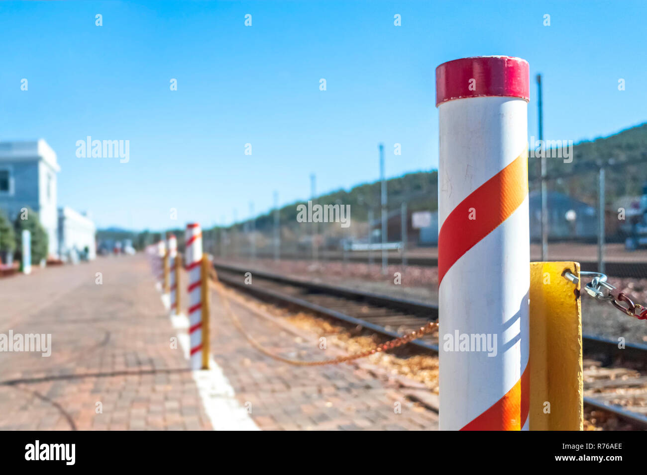 white bollard post with train tracks Stock Photo - Alamy