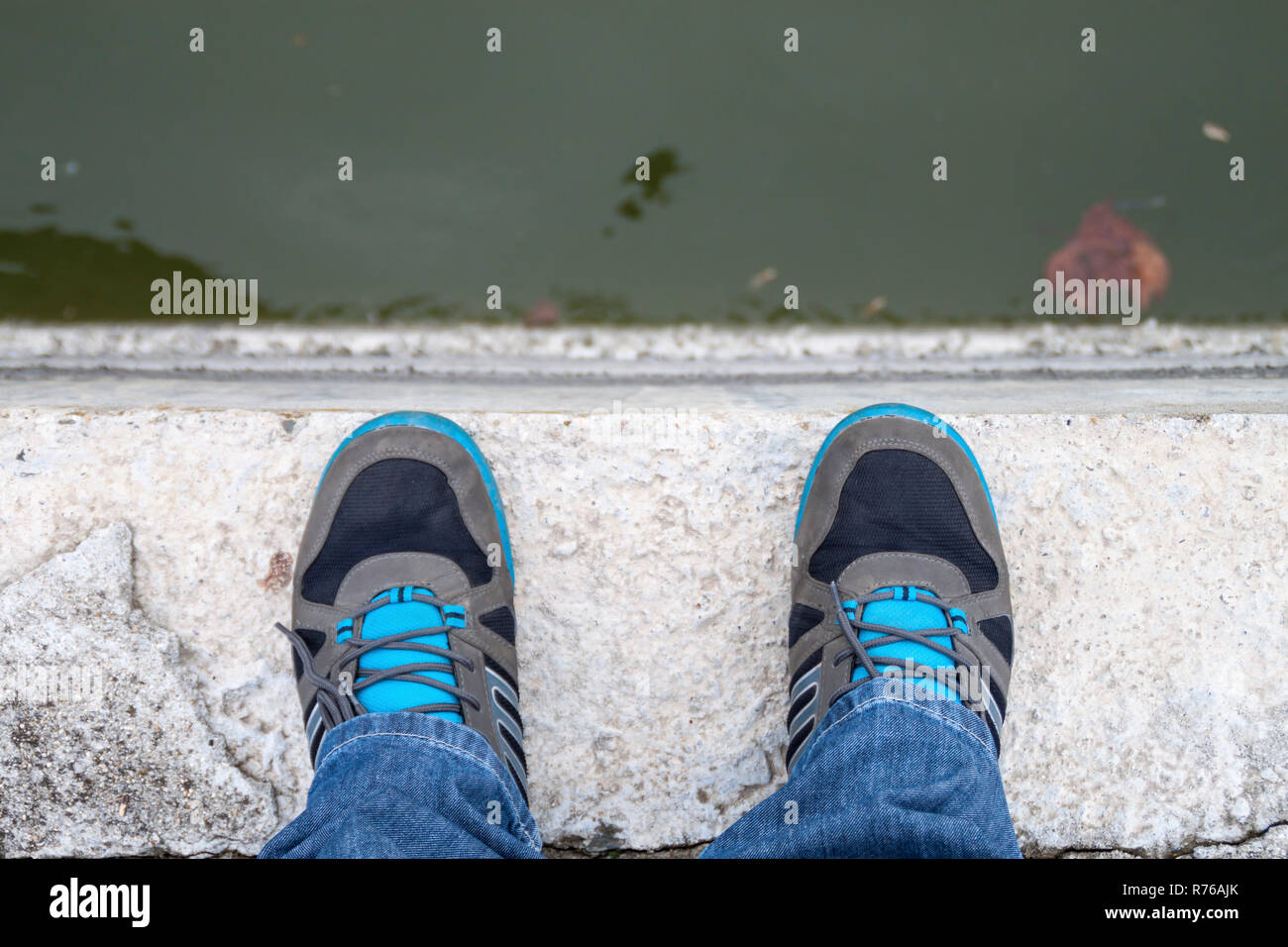 A men standing on the edge of a bridge. First person view Stock Photo ...