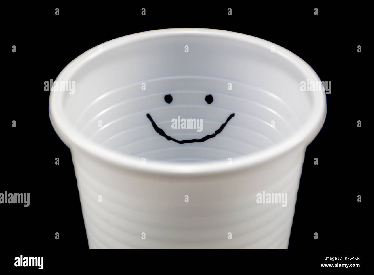 White plastic cup with a smiley face inside Stock Photo - Alamy