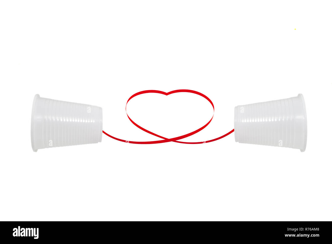 Long distance relationship concept. 2 white plastic cups connected with ...