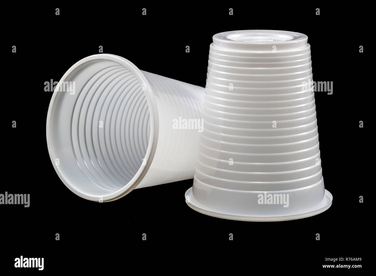 Two plastic cups isolated on black background Stock Photo - Alamy