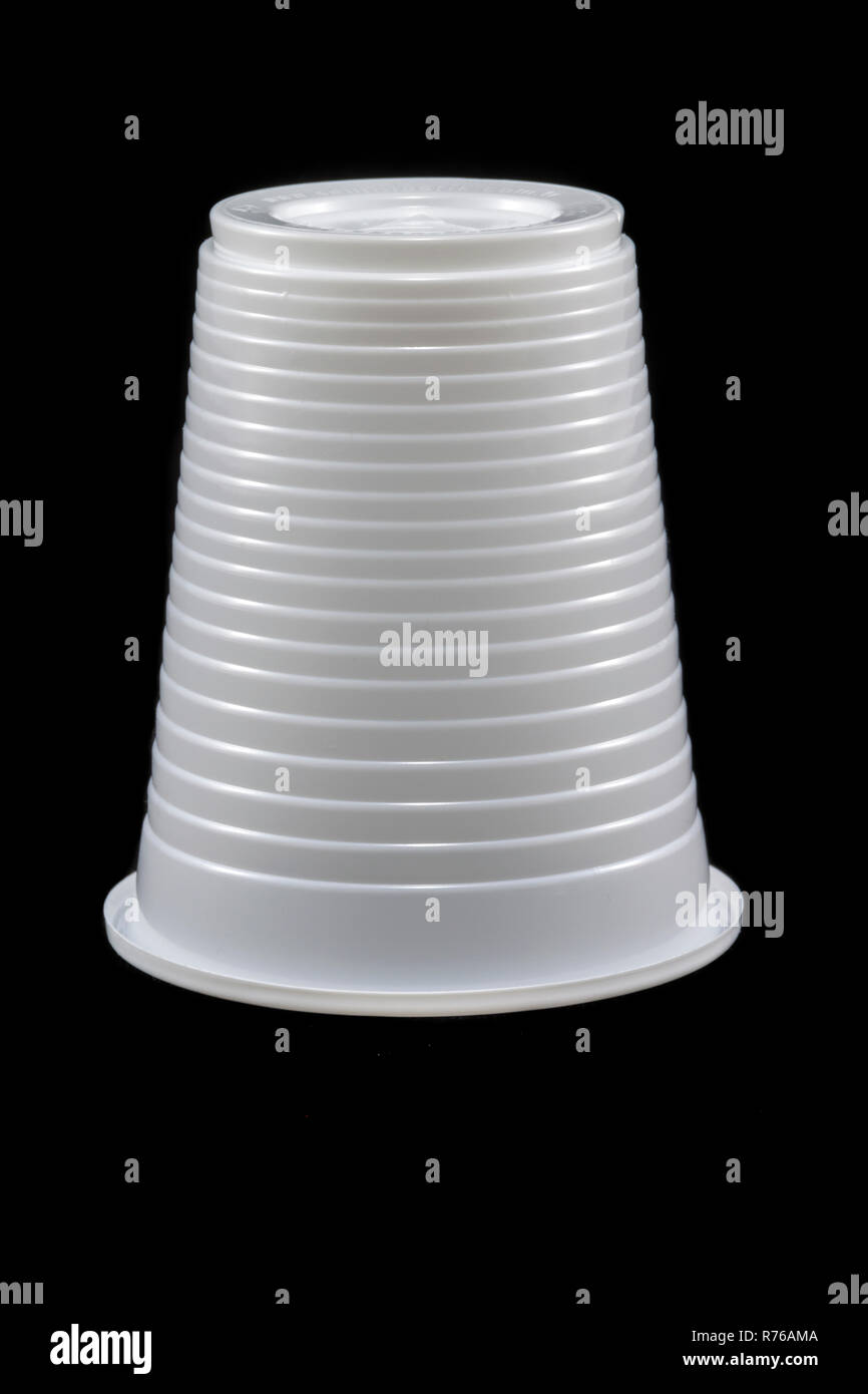 White and ribbed plastic cup isolated on black background Stock Photo ...