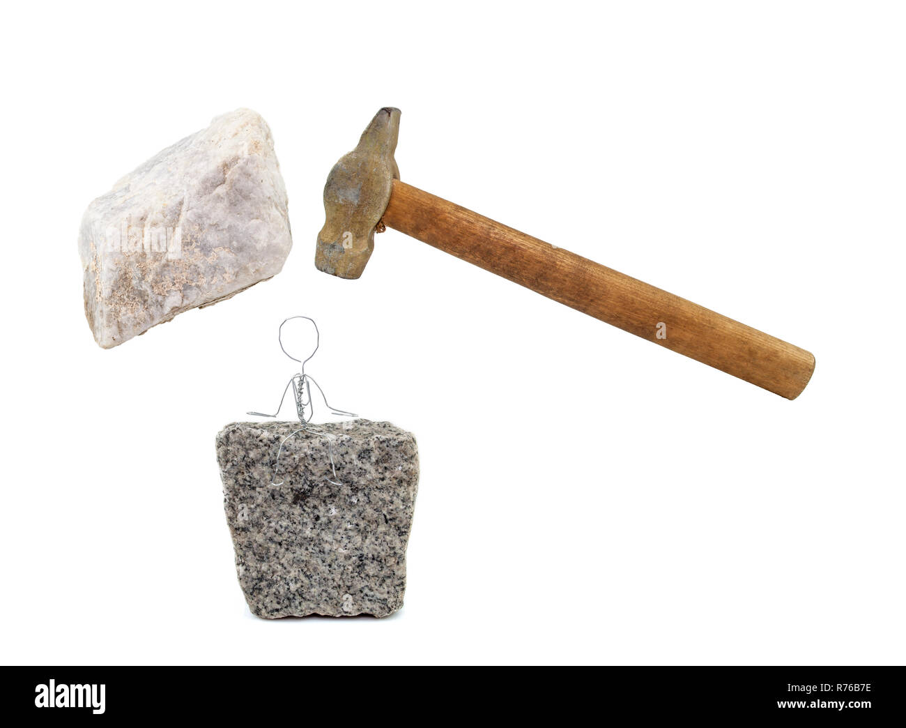 Paperclip figure sitting on a paving stone with a hammer and a rock ...