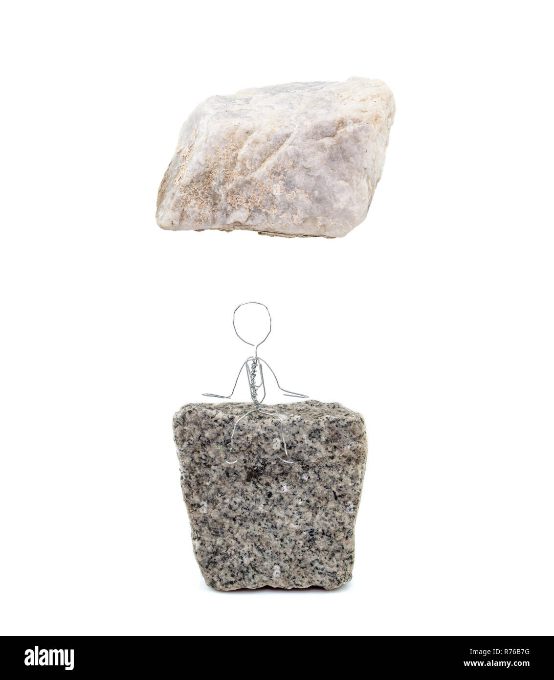 Paperclip figure sitting on a paving stone with a rock over its head ...