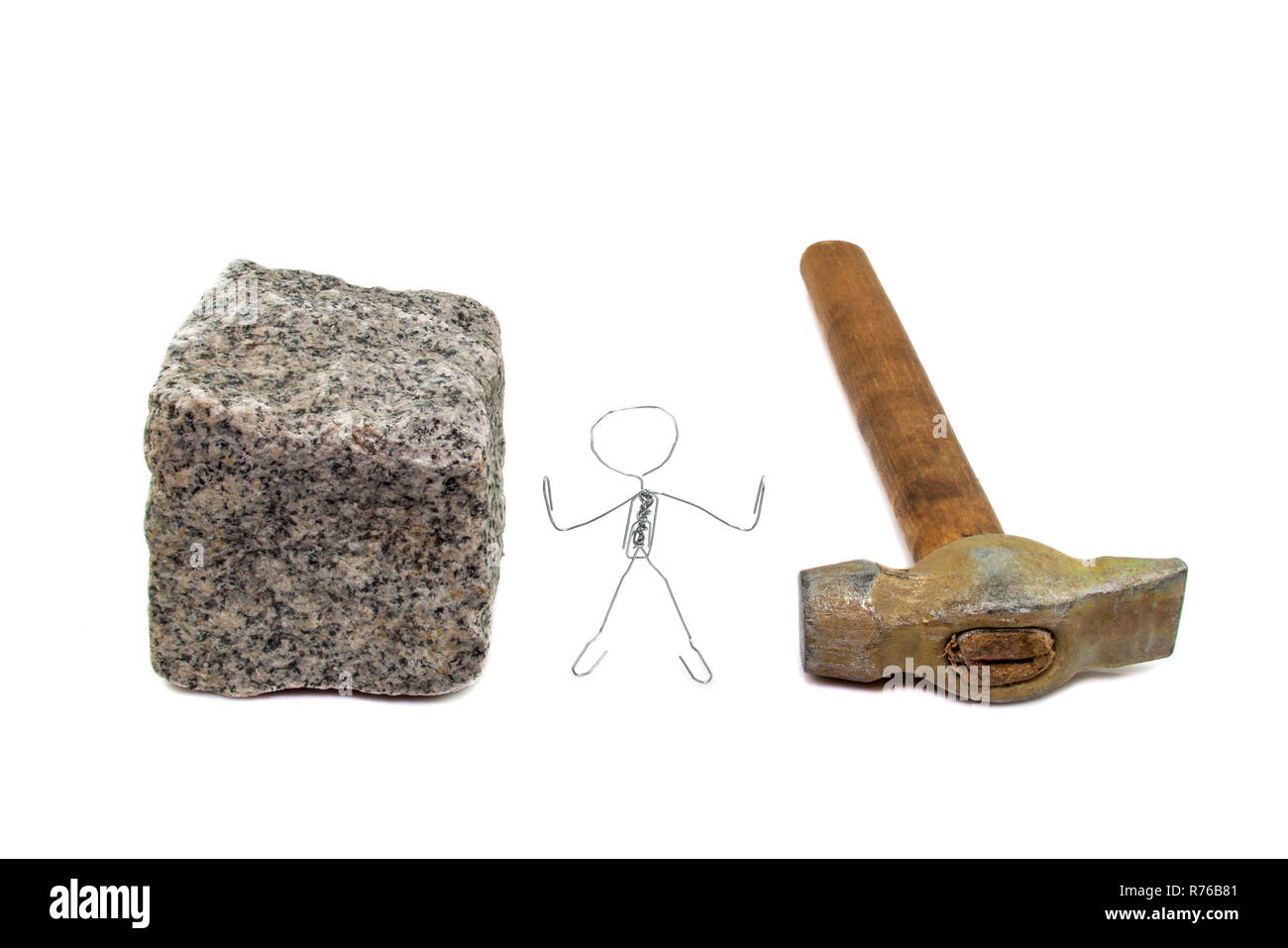 A paperclip figure standing between paving stone and a hammer Stock ...