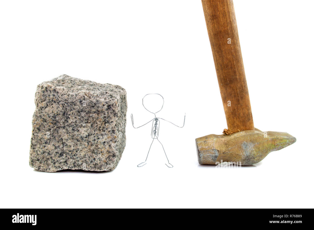 A paperclip figure standing between paving stone and a hammer Stock ...