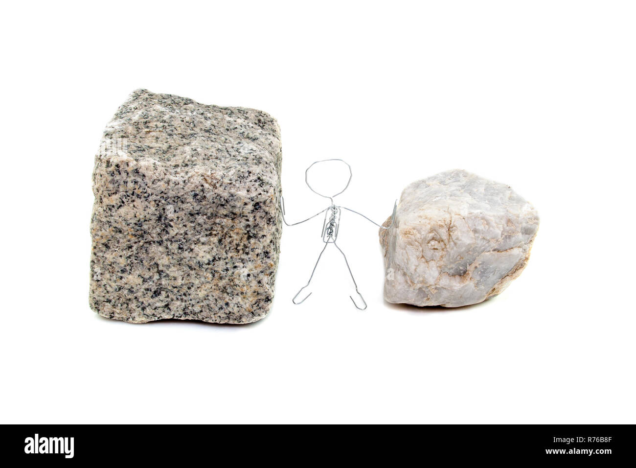 A paperclip figure standing between paving stone and a marble stone ...