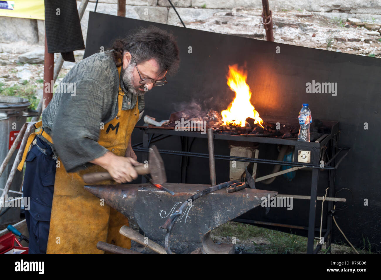 Blacksmith working on his next masterpiece Stock Photo - Alamy
