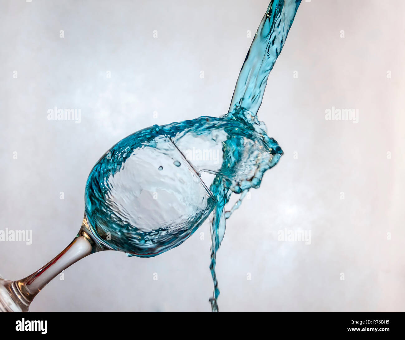 Interesting way for pouring blue drink in a glass Stock Photo - Alamy