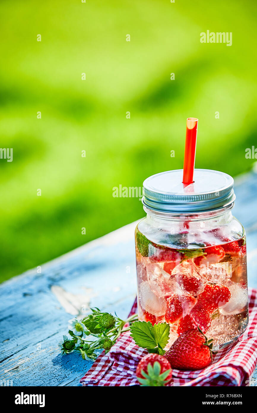 Chilled berry infused strawberry punch bowl in a glass jar Stock Photo ...