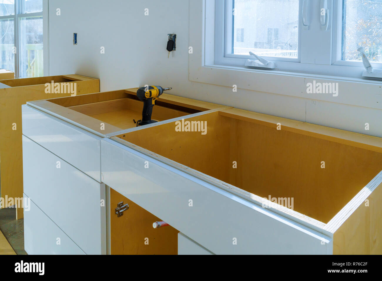 Custom kitchen cabinets in various stages of installation base for ...