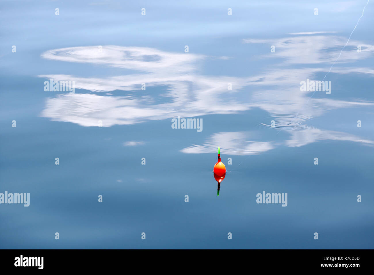 Fishing float on the water with waves and beautiful reflection Stock ...