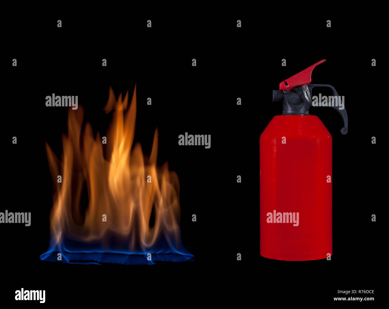 Human hand holding fire extinguisher and a blue flame isolated on black ...