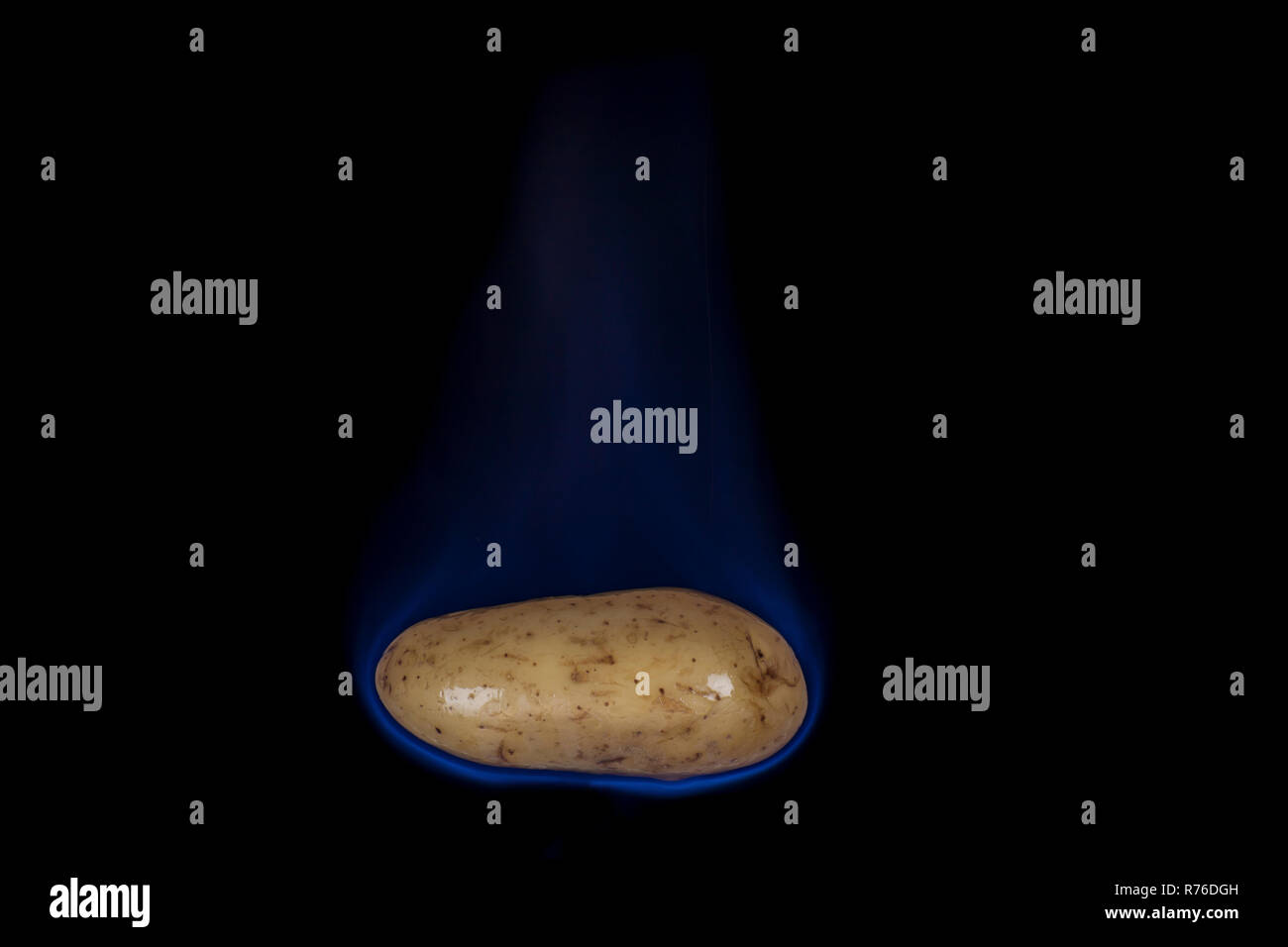Potato on fire with blue flames isolated on black background Stock ...