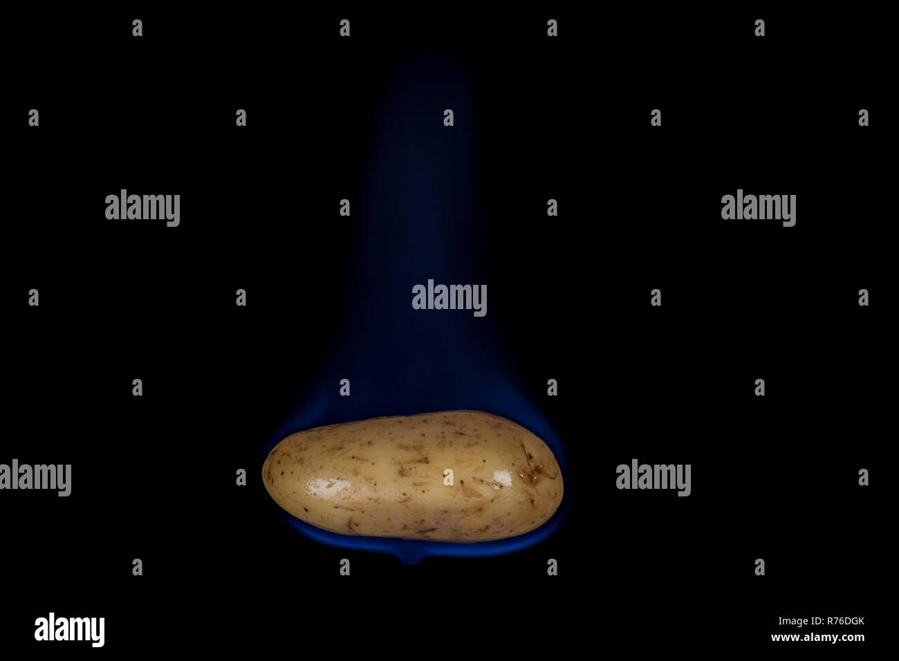 Potato on fire with blue flames isolated on black background Stock ...