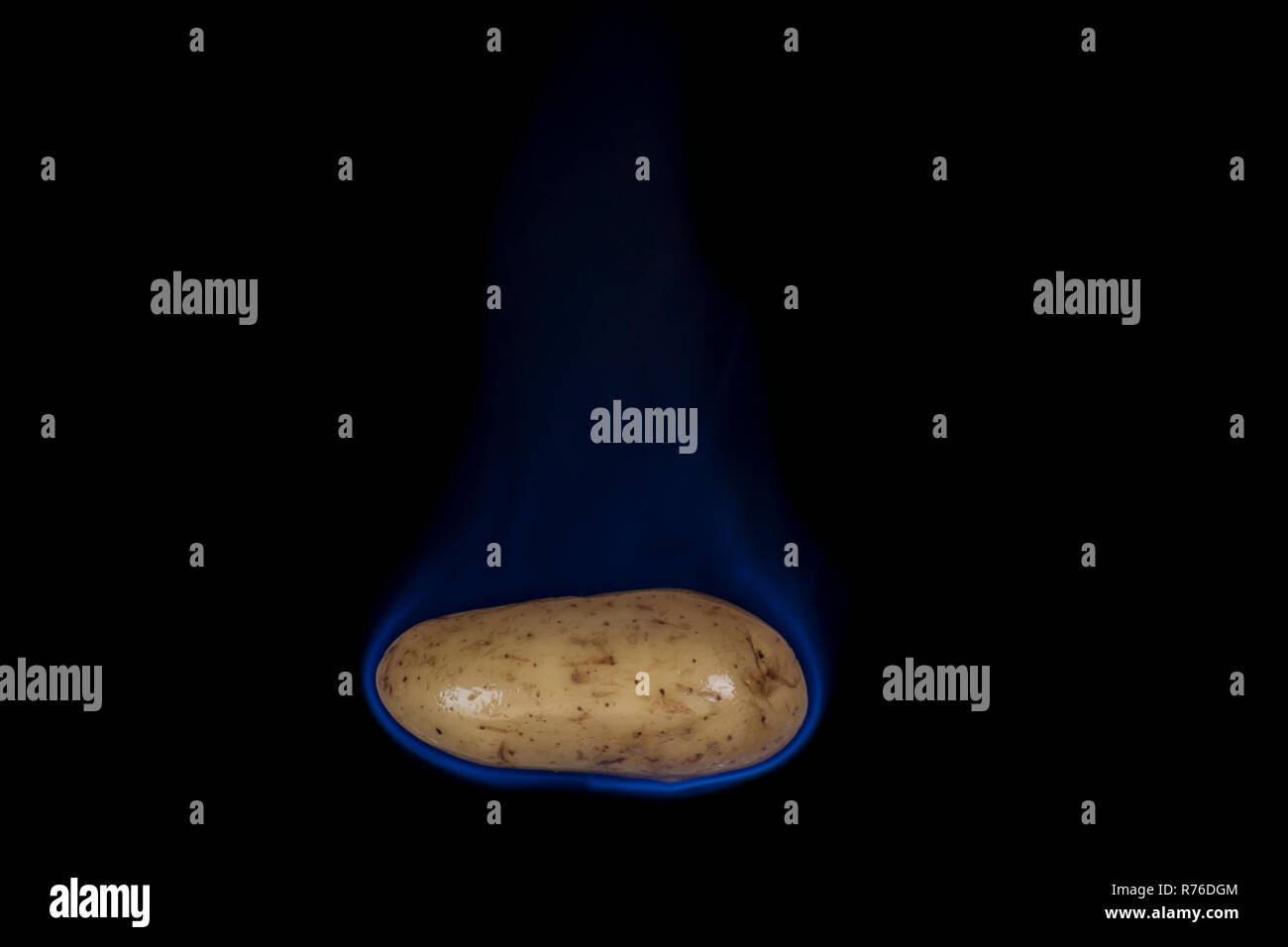 Potato on fire with blue flames isolated on black background Stock ...
