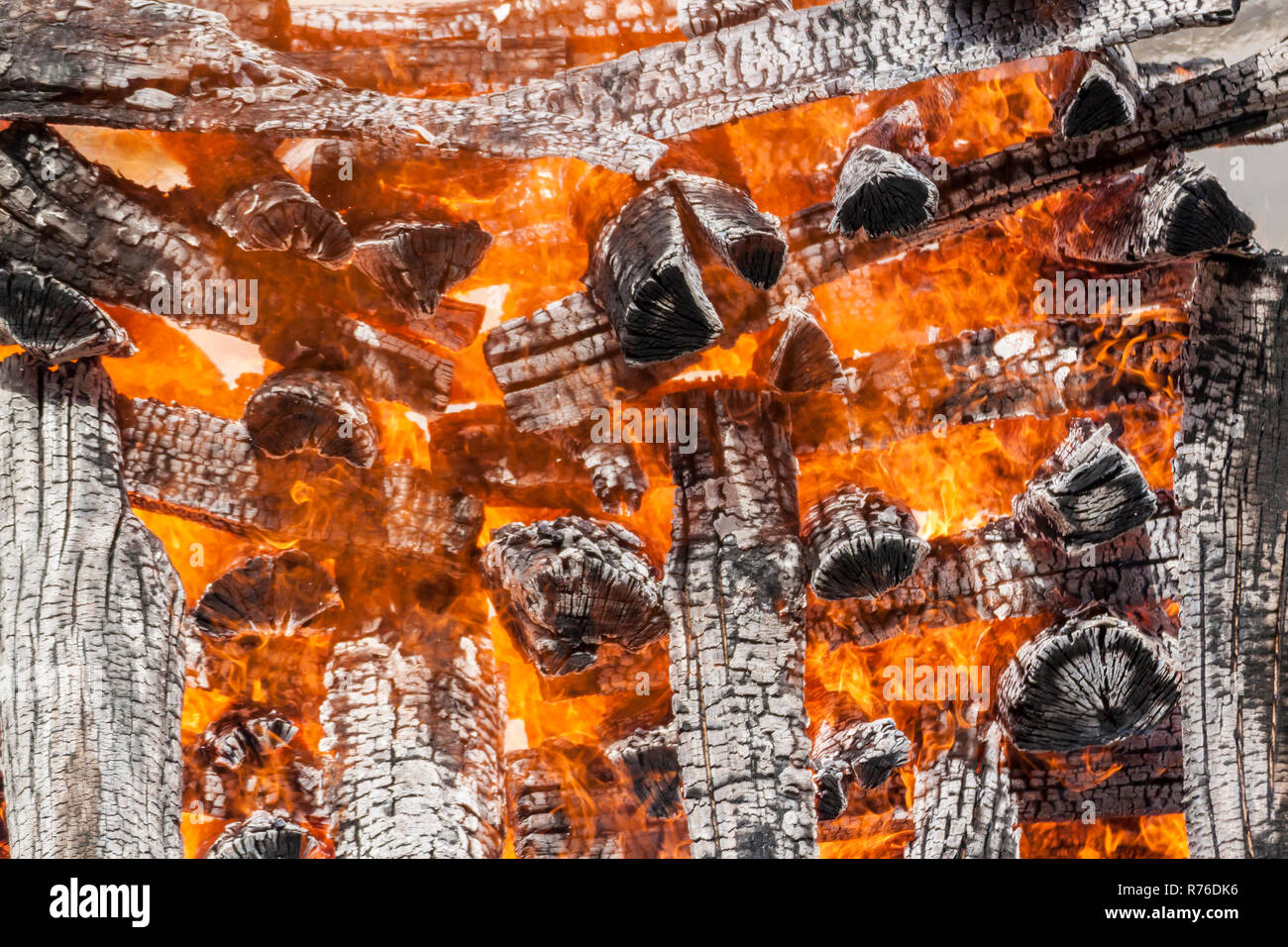 Wood logs arranged as a stack set on fire Stock Photo - Alamy