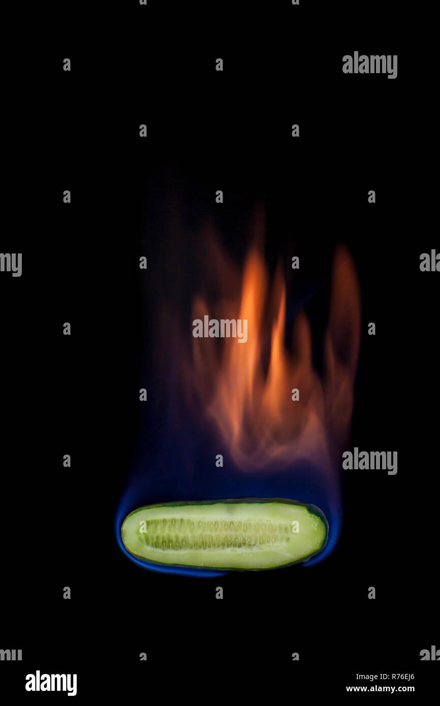 Cucumber on fire with blue flames isolated on black background Stock ...