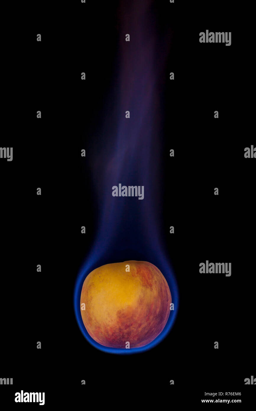 Peach on fire with blue flames isolated on black background Stock Photo ...