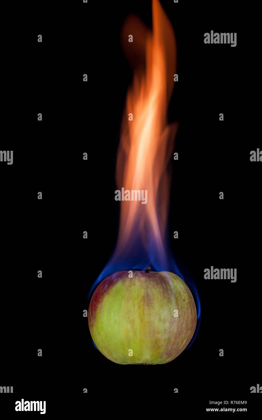 Apple on fire with blue flames isolated on black background Stock Photo ...