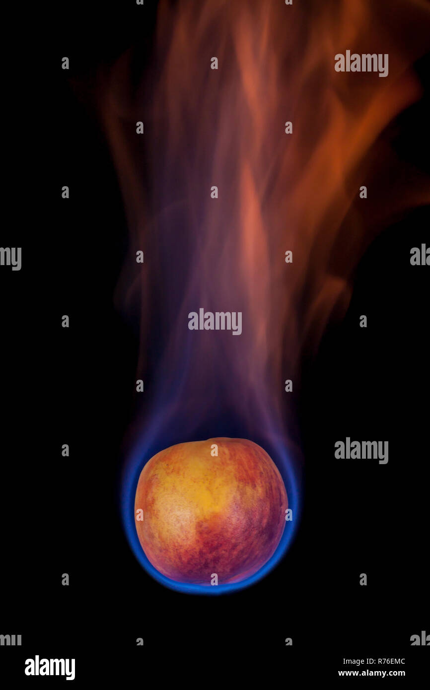 Peach on fire with blue flames isolated on black background Stock Photo ...