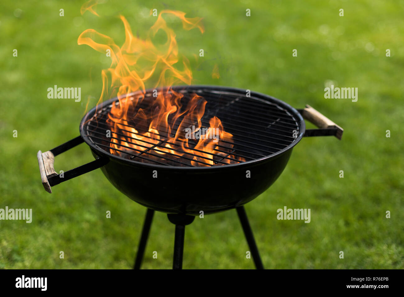 Barbecue grill with fire on nature, outdoor, close up Stock Photo - Alamy