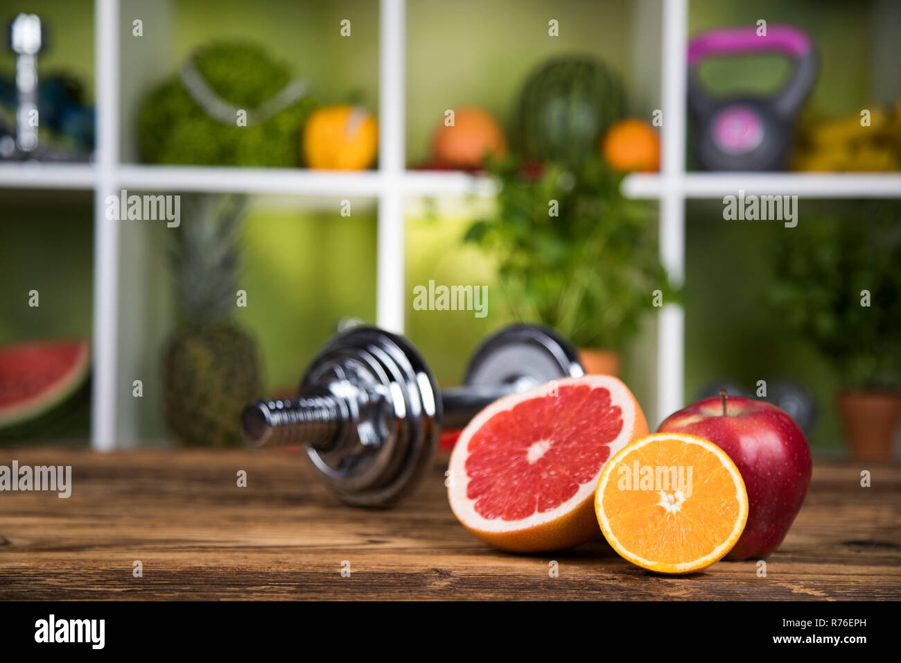 Fitness concept with dumbbells and fresh fruits Stock Photo - Alamy