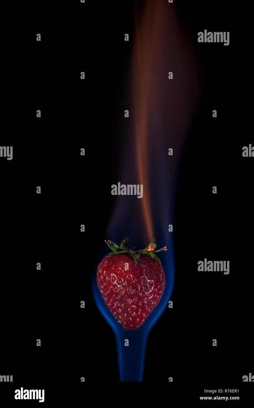 Strawberry on fire with blue flames isolated on black background Stock ...