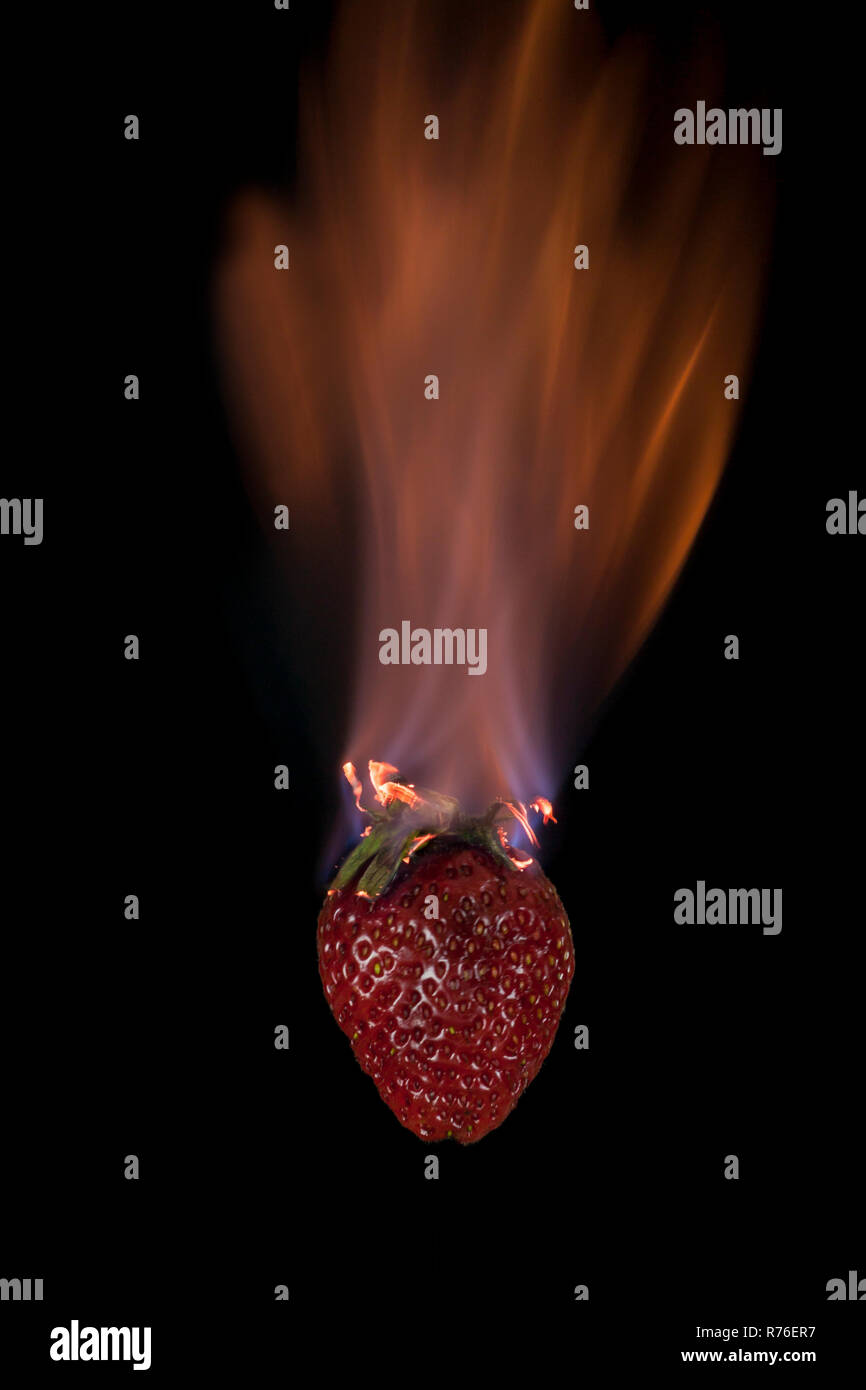 Strawberry on fire with blue flames isolated on black background Stock ...