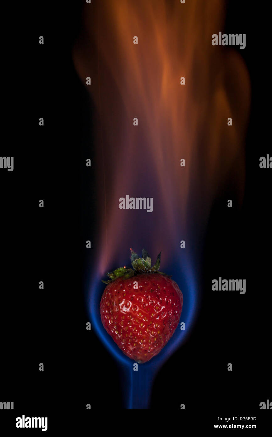 Strawberry on fire with blue flames isolated on black background Stock ...