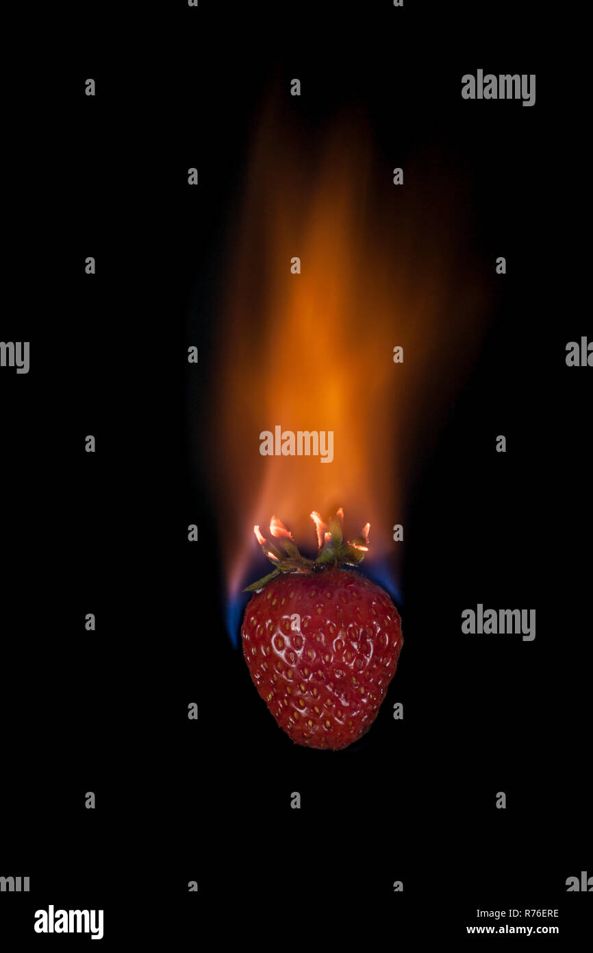 Strawberry on fire with blue flames isolated on black background Stock ...