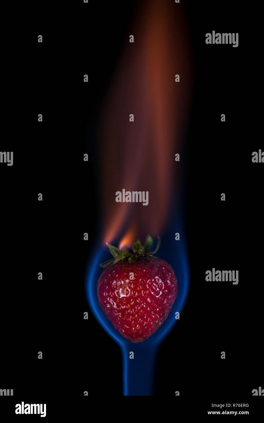 Strawberry on fire with blue flames isolated on black background Stock ...
