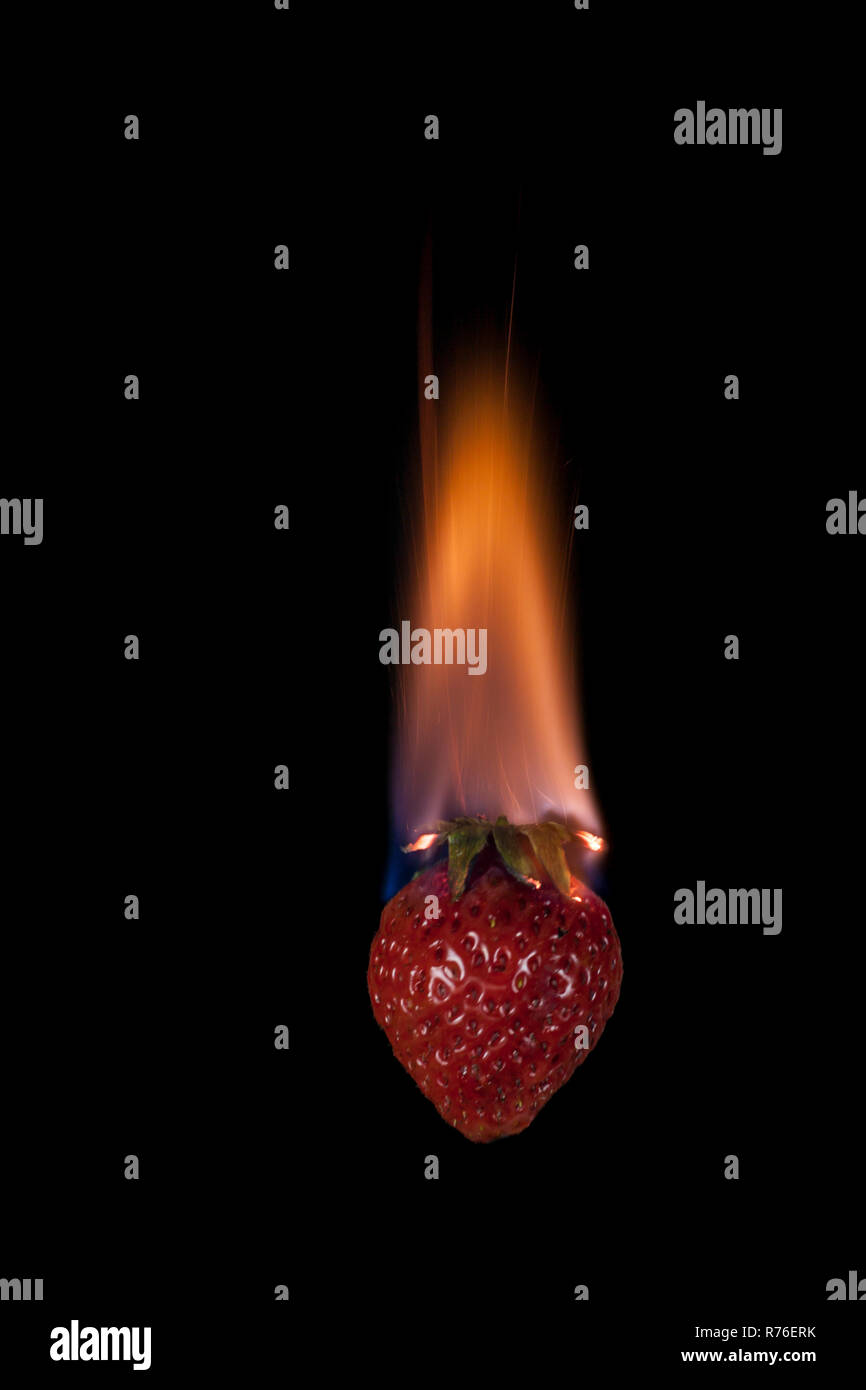 Strawberry on fire with blue flames isolated on black background Stock ...