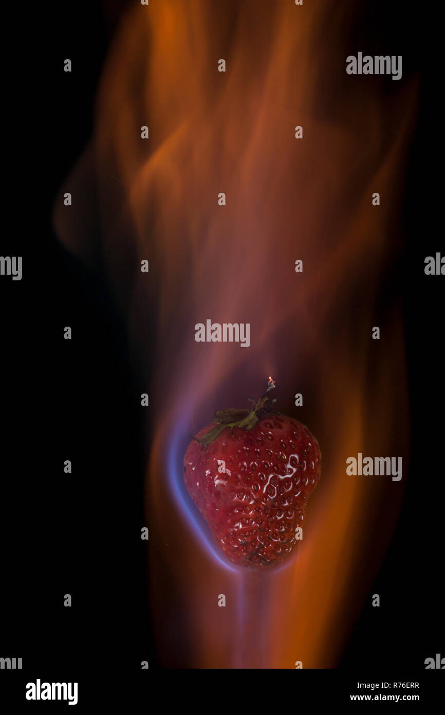 Strawberry on fire with blue flames isolated on black background Stock ...