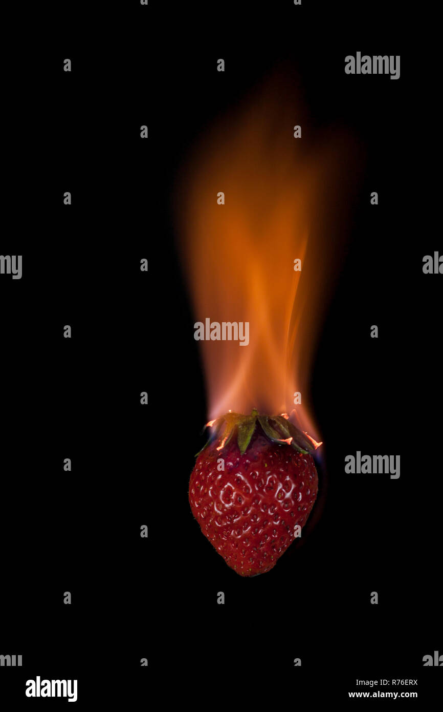 Strawberry on fire with blue flames isolated on black background Stock ...
