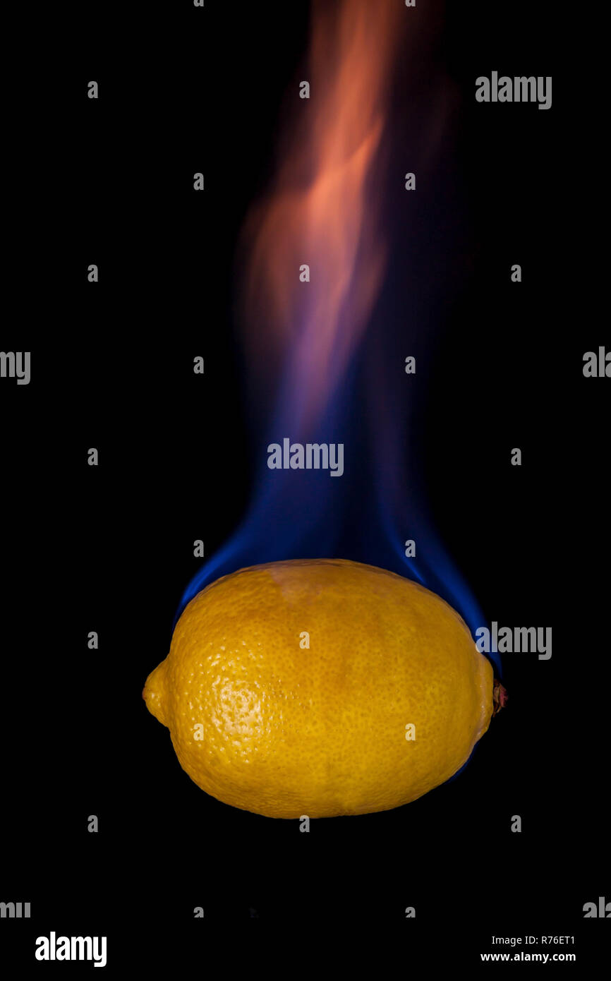 Lemon ot fire with blue flames isolated on black background Stock Photo ...