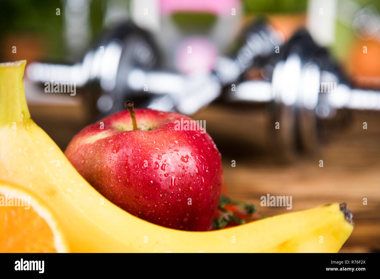 Fitness concept with dumbbells and fresh fruits Stock Photo - Alamy