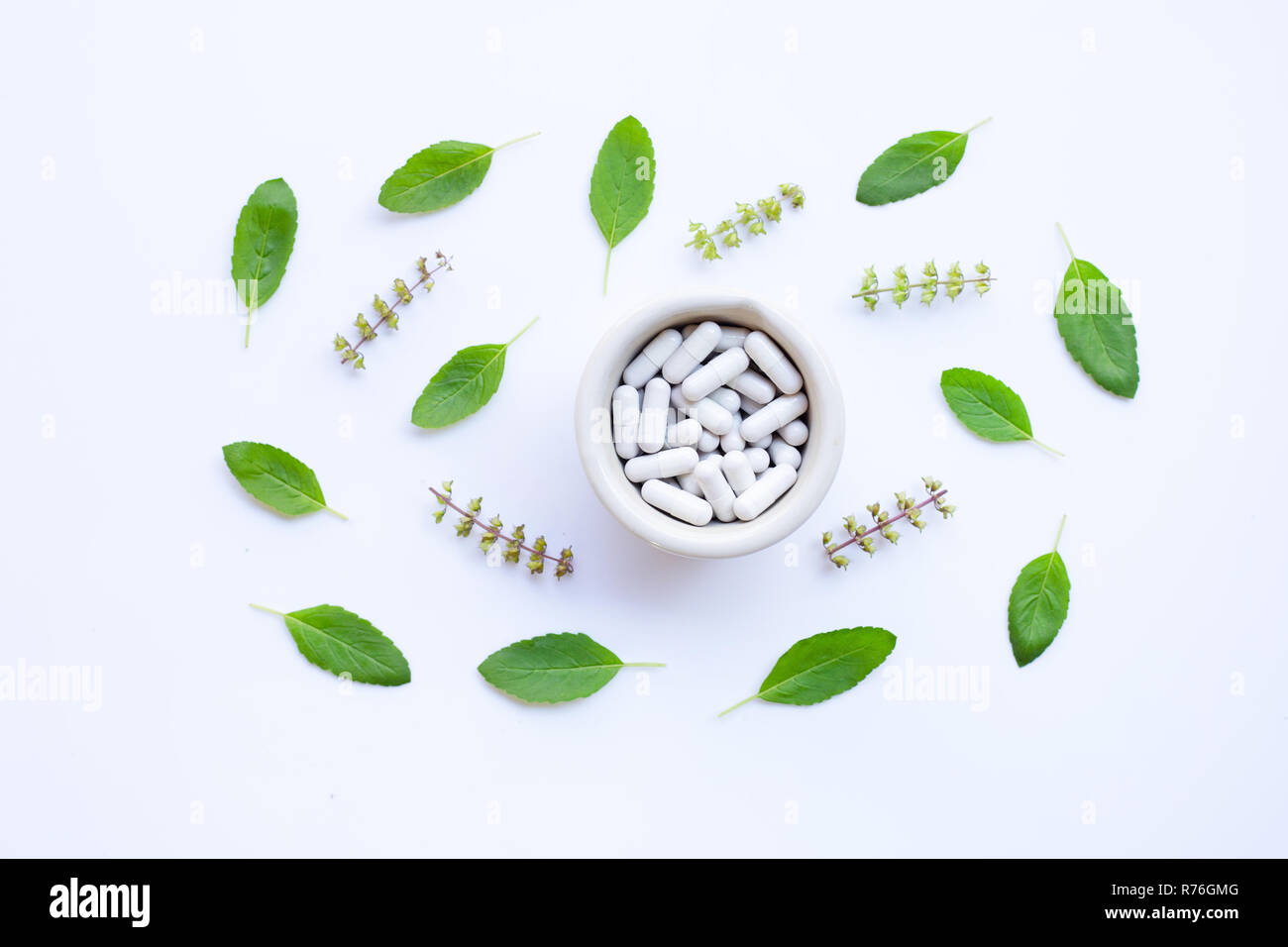 Flower of holy basil and leaves with herbal medicinecapsules pills on ...