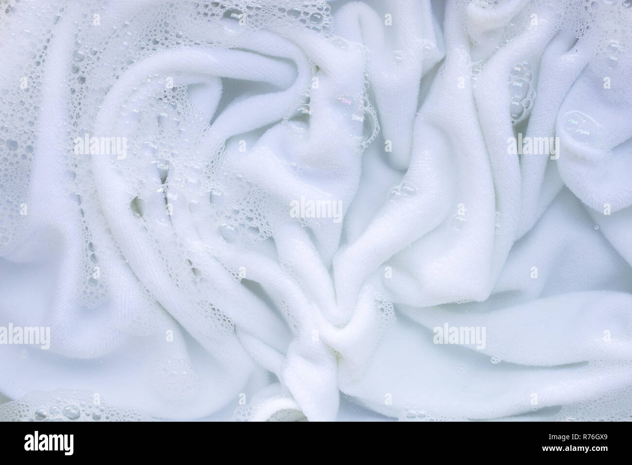 Soak a cloth before washing, white cloth Stock Photo - Alamy