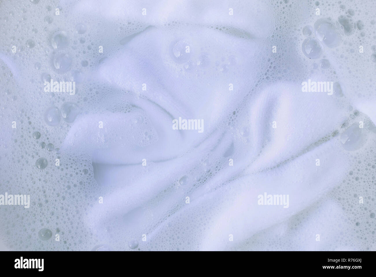 Soak a cloth before washing, white cloth Stock Photo - Alamy