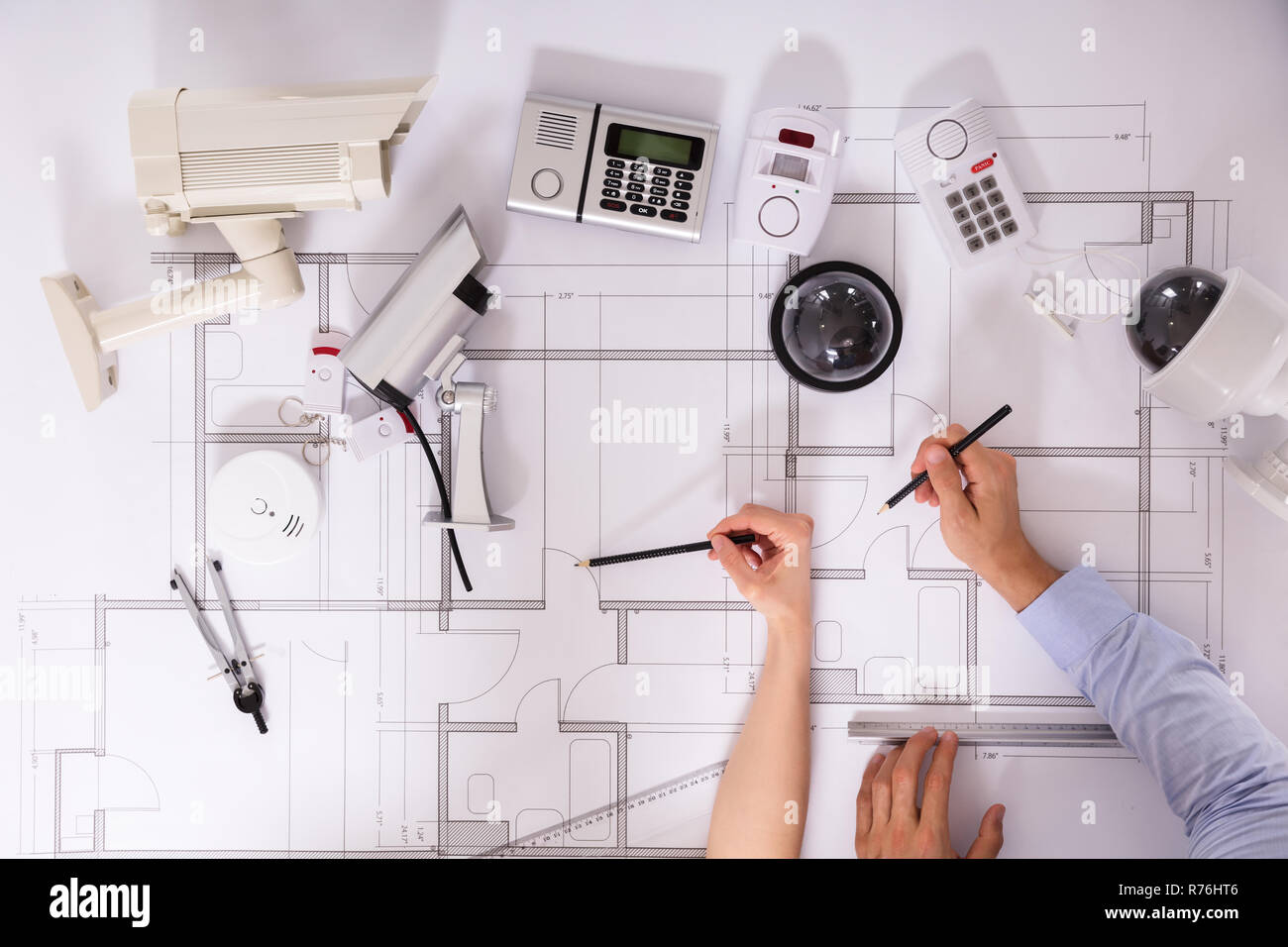 Two Architects Planning Project On Blueprint Stock Photo - Alamy