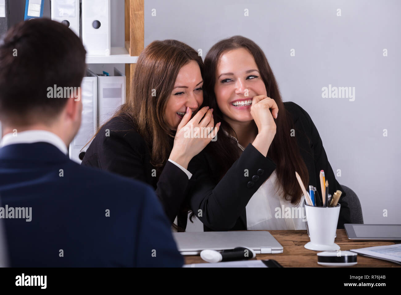 Male colleague telling gossip work hi-res stock photography and images ...